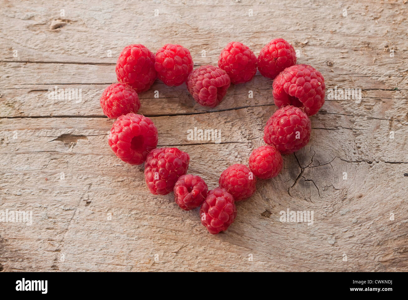 some raspberries in a heart shape Stock Photo - Alamy