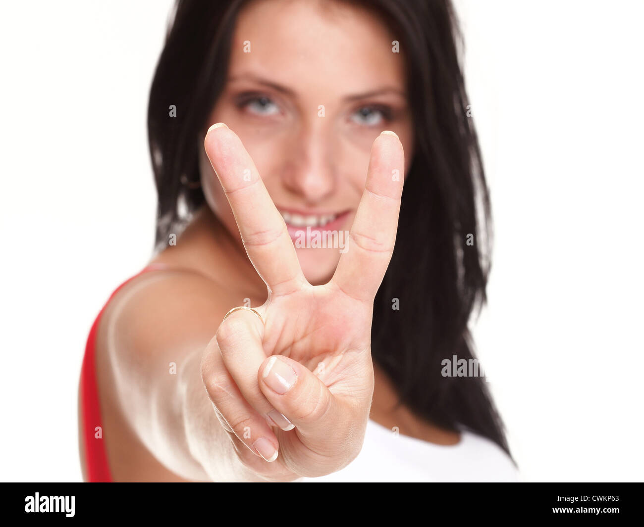 Portrait of a pretty young woman showing the peace sign Stock Photo - Alamy