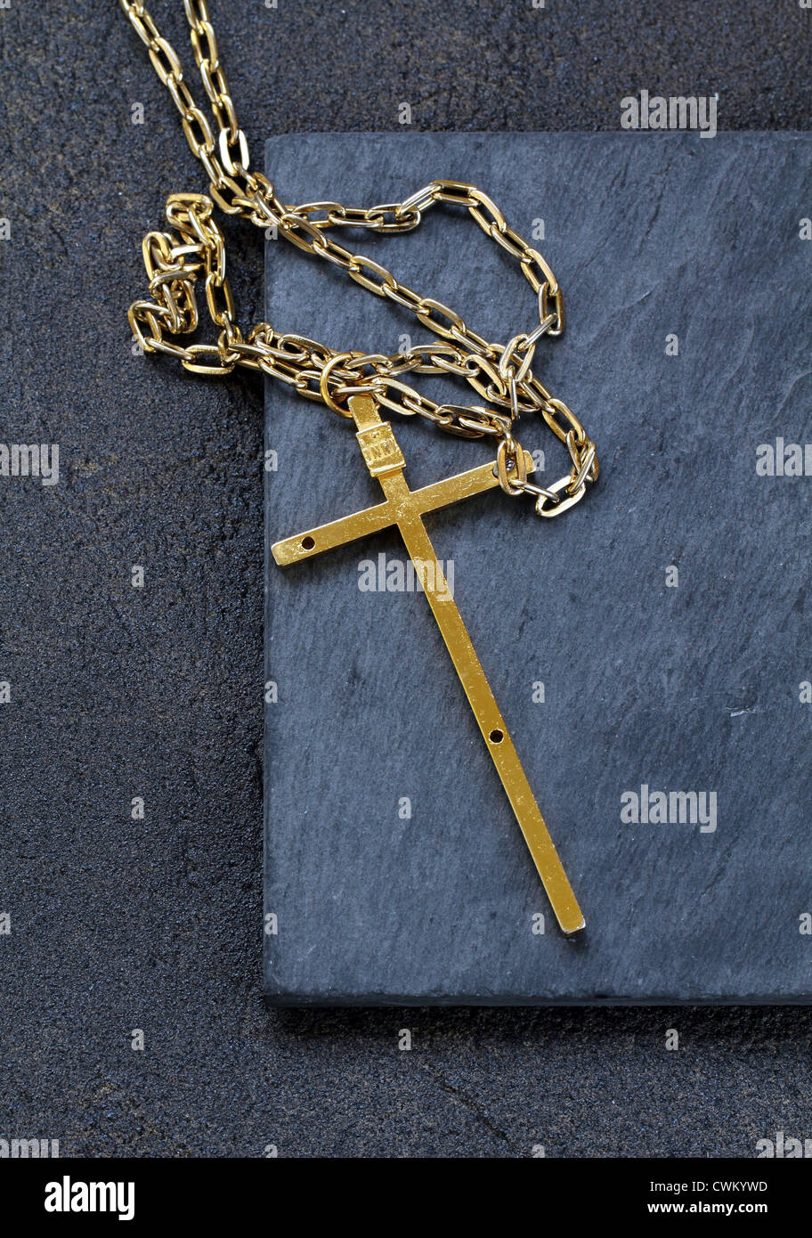 gold cross on a black background - a religion symbol Stock Photo - Alamy
