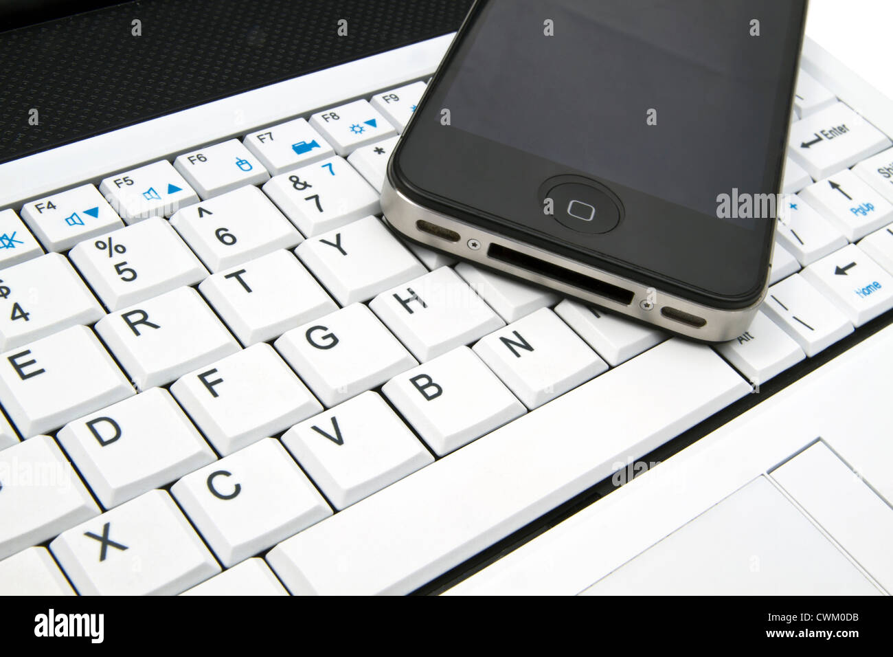 smart phone on laptop keyboard background Stock Photo - Alamy