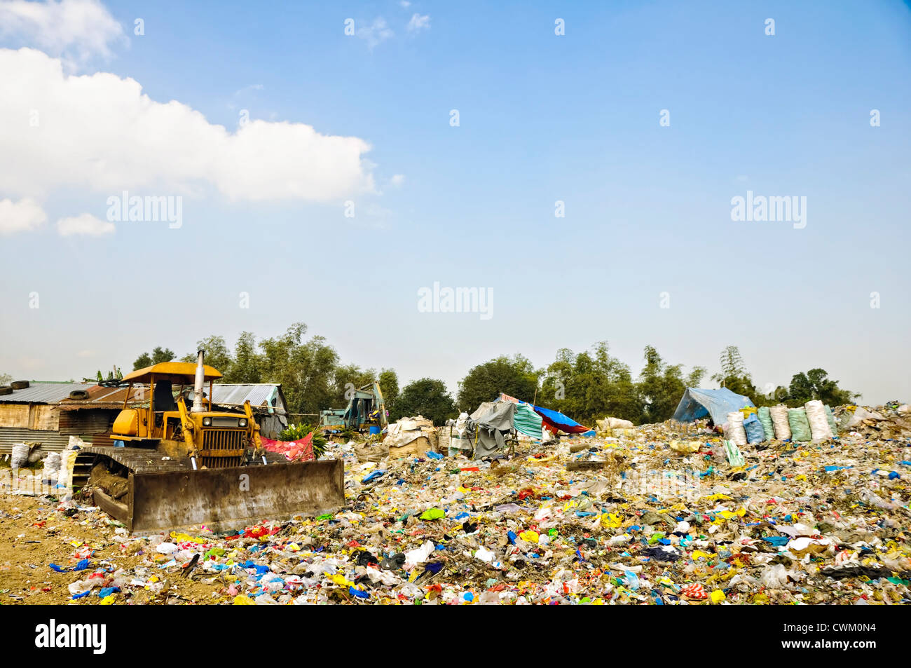 Bulldozer in the middle of garbage dump Stock Photo - Alamy