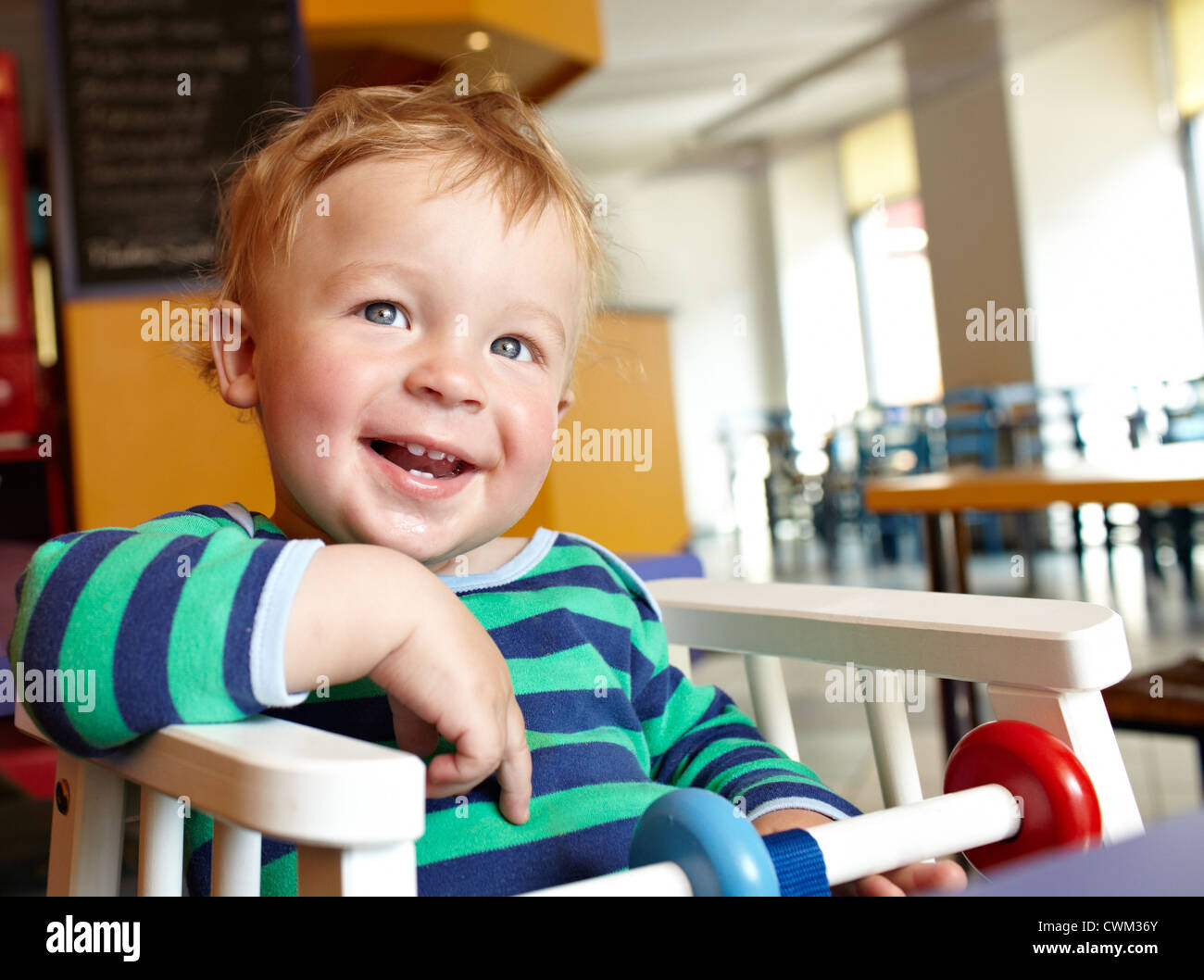 Cute boy having delicious lunch in restaurant and laughing. Natural ...