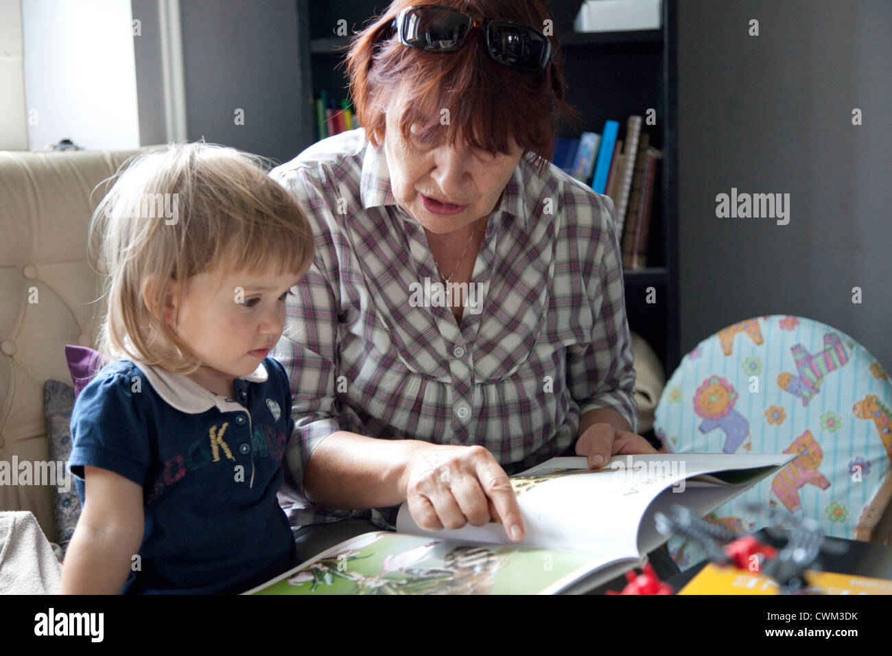 Polish grandma (babcia) reading to her young granddaughter age 63 and 2 ...