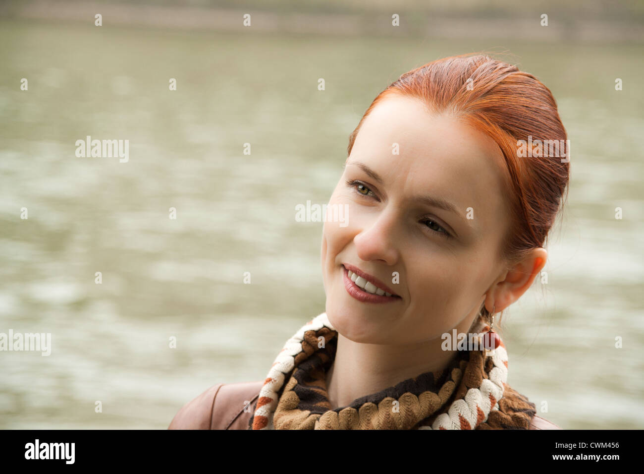 A beautiful lady with red hair, giving a gentle smile Stock Photo - Alamy