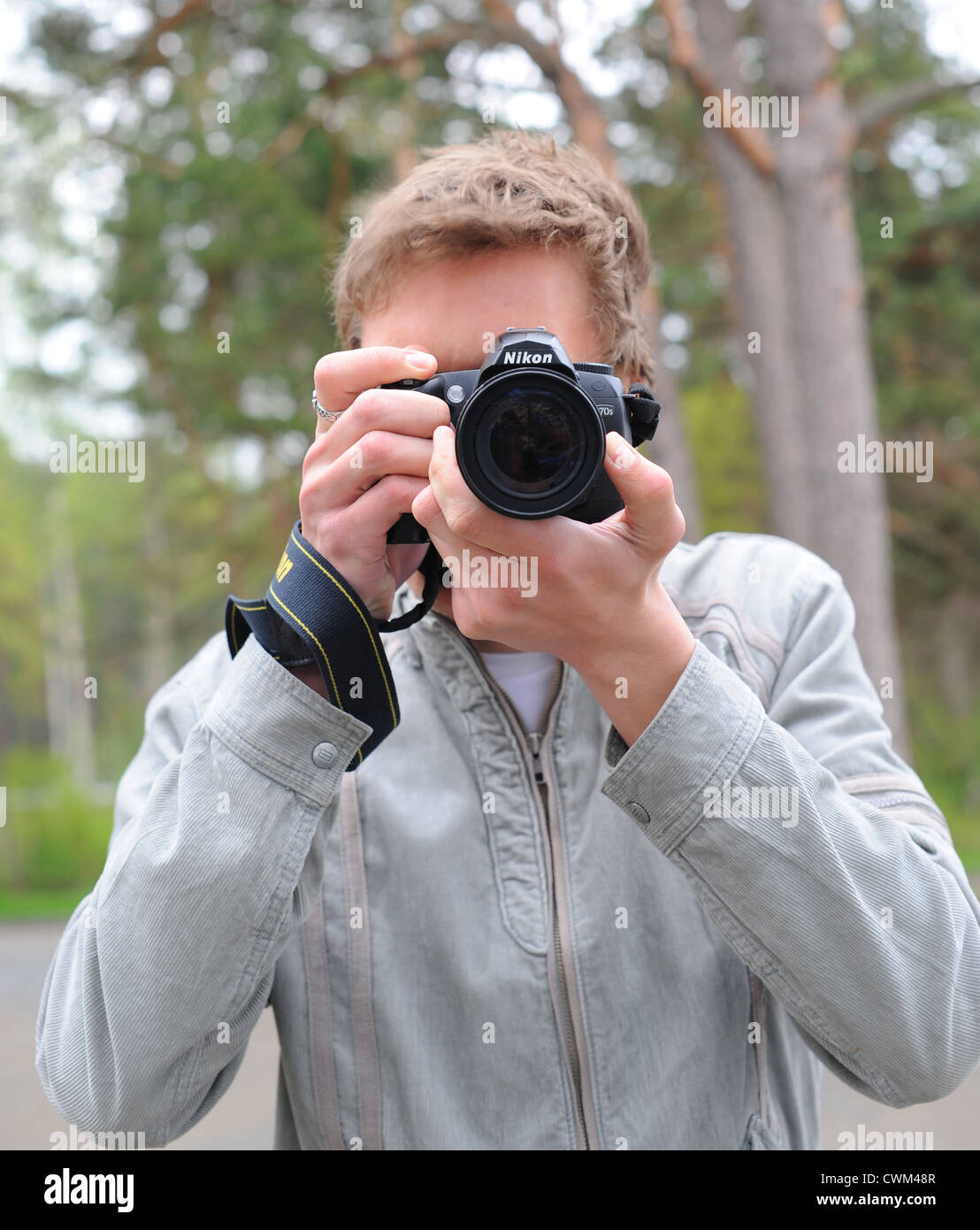 Male photographer taking photo with a Nikon DSLR camera Stock Photo - Alamy
