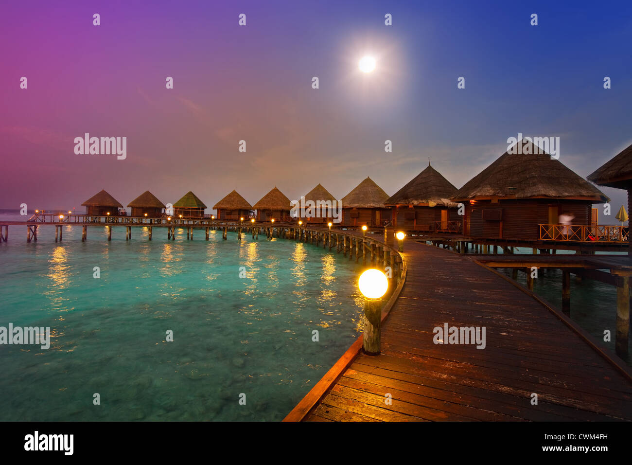 houses on piles on water at night in fool moon light Stock Photo - Alamy