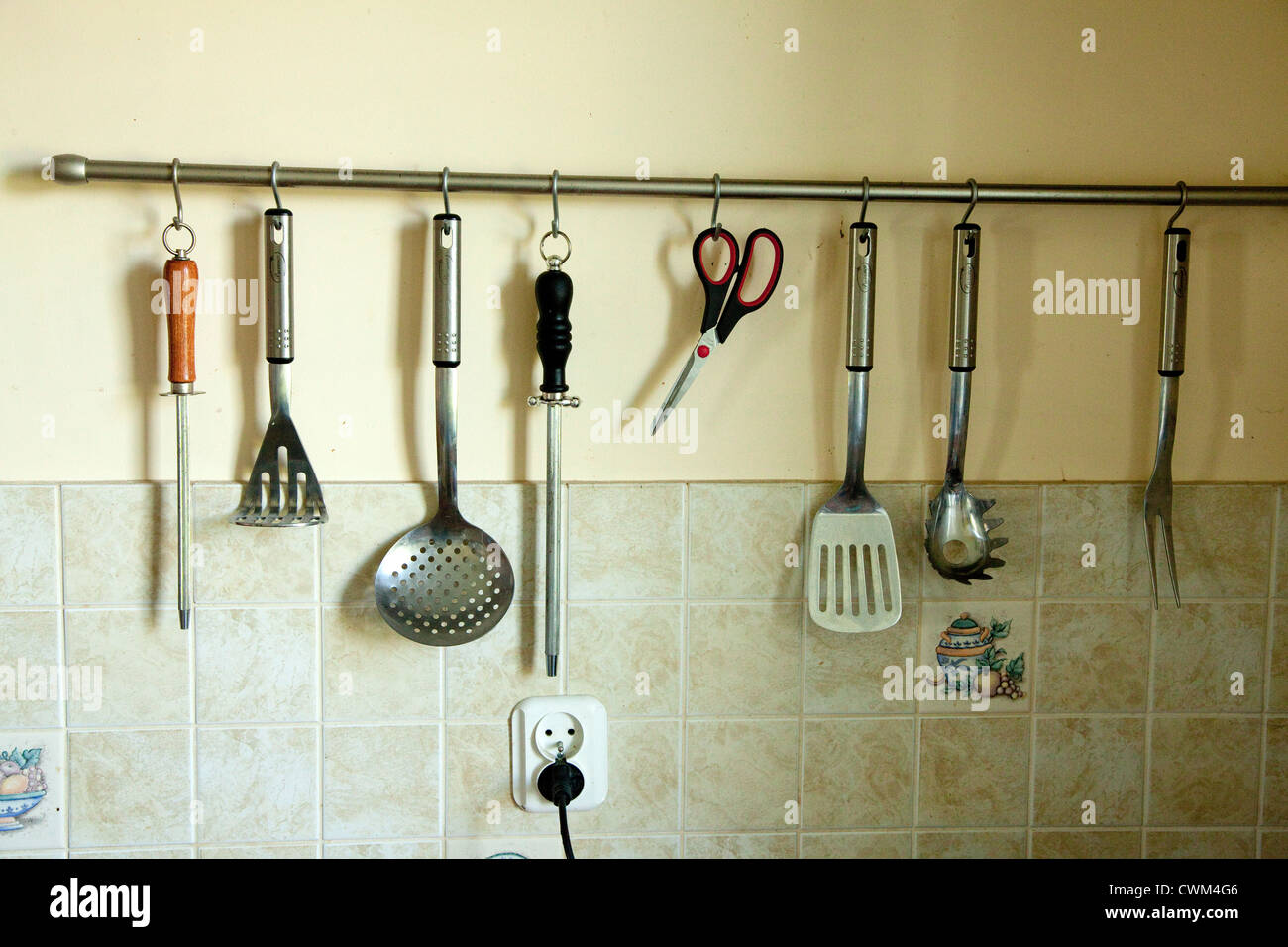 Kitchen tools hung up on wall ready for use in a Polish kitchen. Zawady ...
