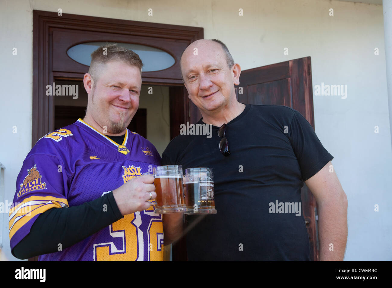 Polish father-in-law and happy son-in-law having a friendly nostrovia ...