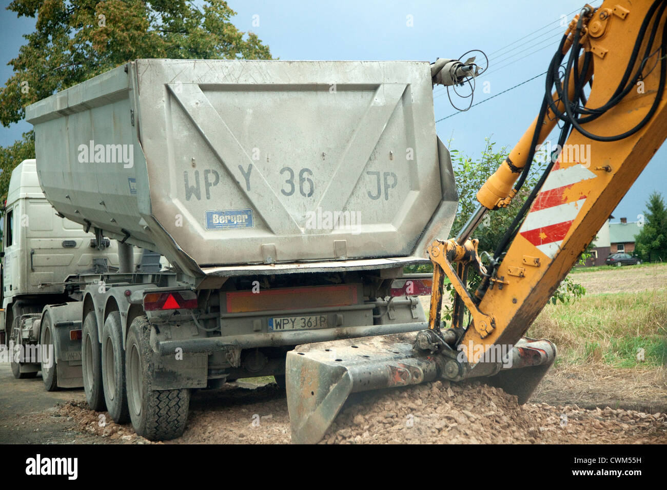 Polish road repairing with dump truck and front end loader. Zawady ...