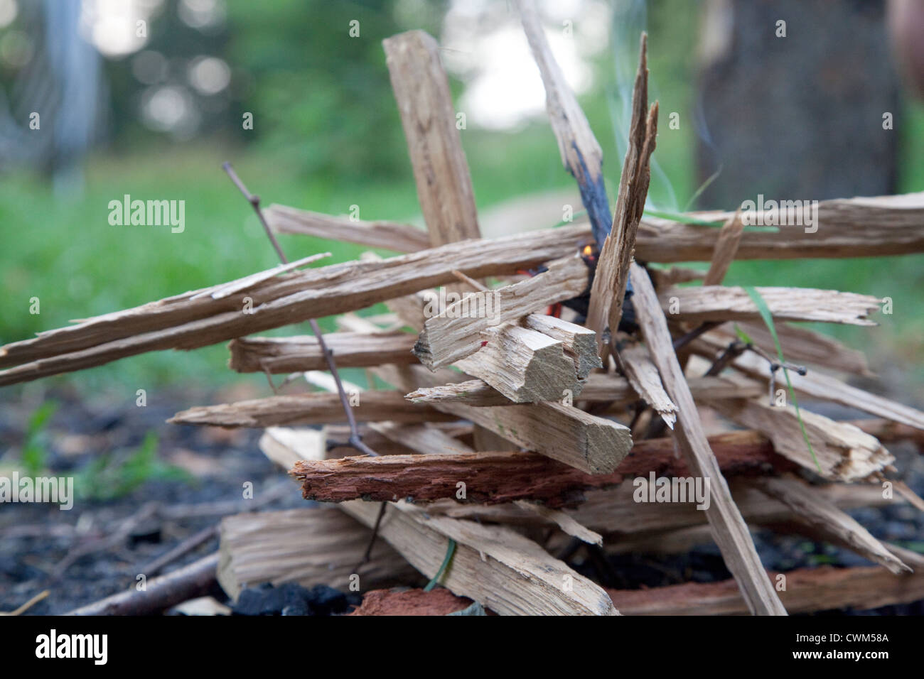 Fire starting from a square orderly small split pieces of kindling wood ...