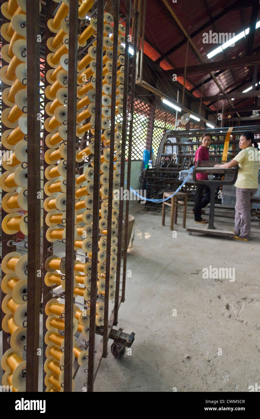 Vertical close up of women spinning the reels of unusable single ...