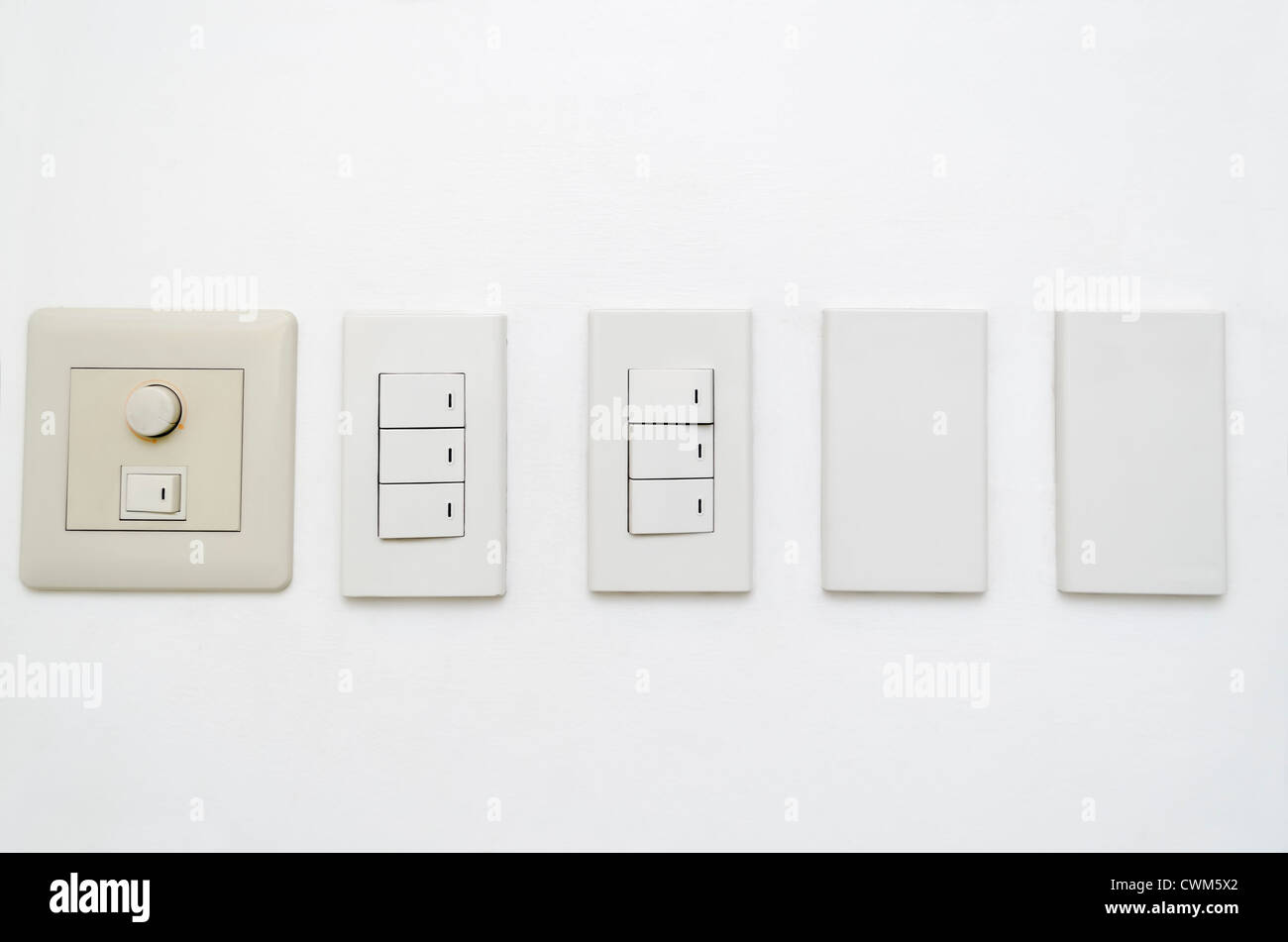 White light switches on white wall Stock Photo - Alamy