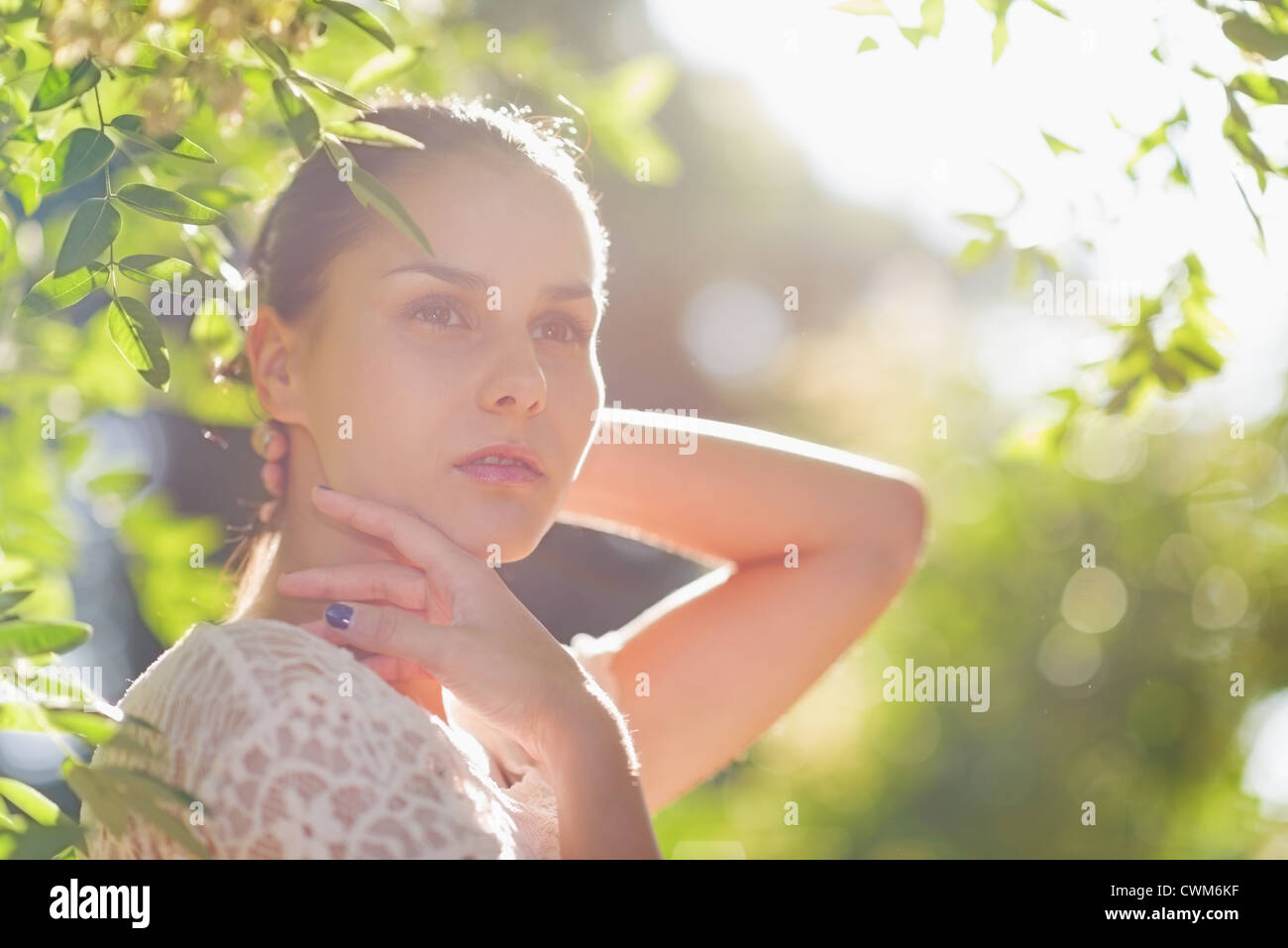 Portrait of thoughtful young woman in forest Stock Photo - Alamy
