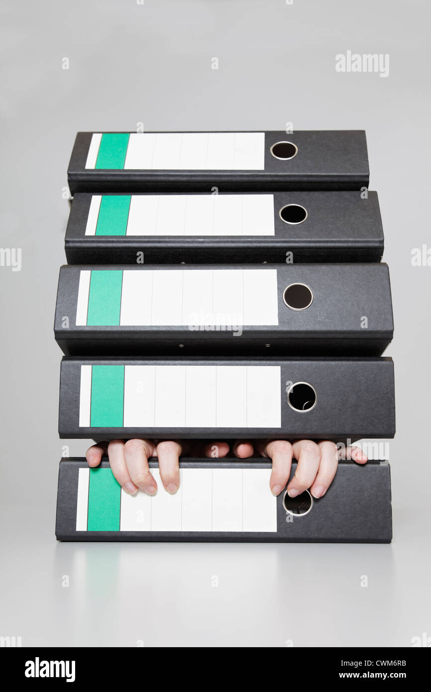 Germany, Human fingers stuck in stack of file Stock Photo - Alamy