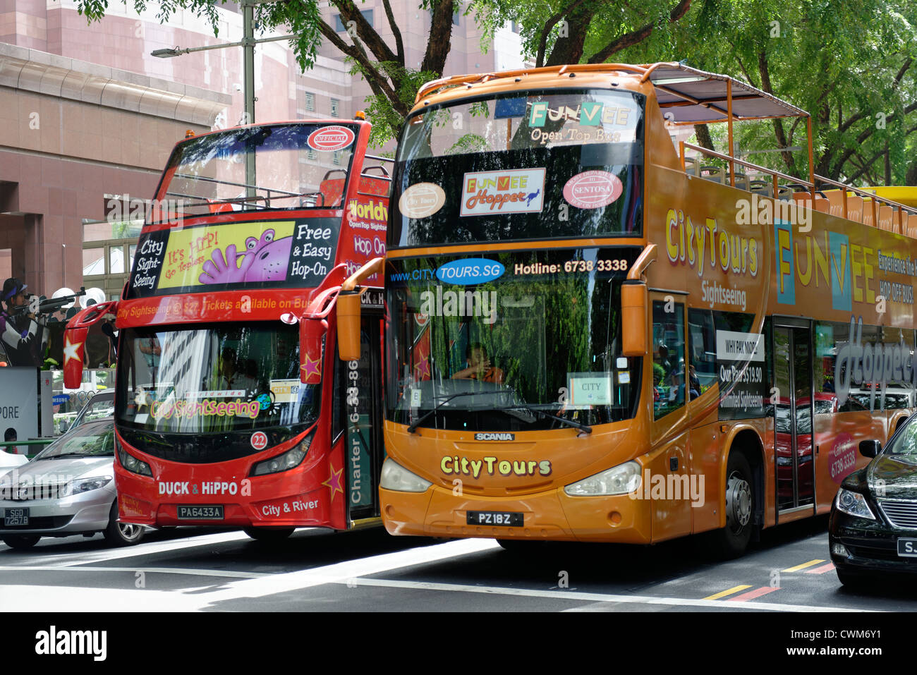Red and orange Singapore tour buses on Orchard Road, Singapore Stock ...