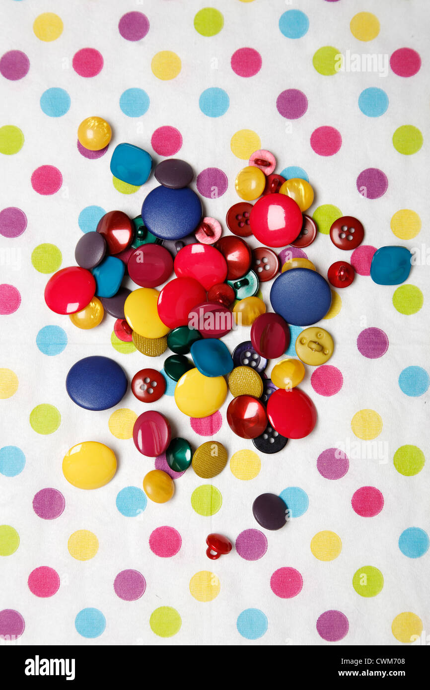 Variety of buttons on dotted background Stock Photo - Alamy