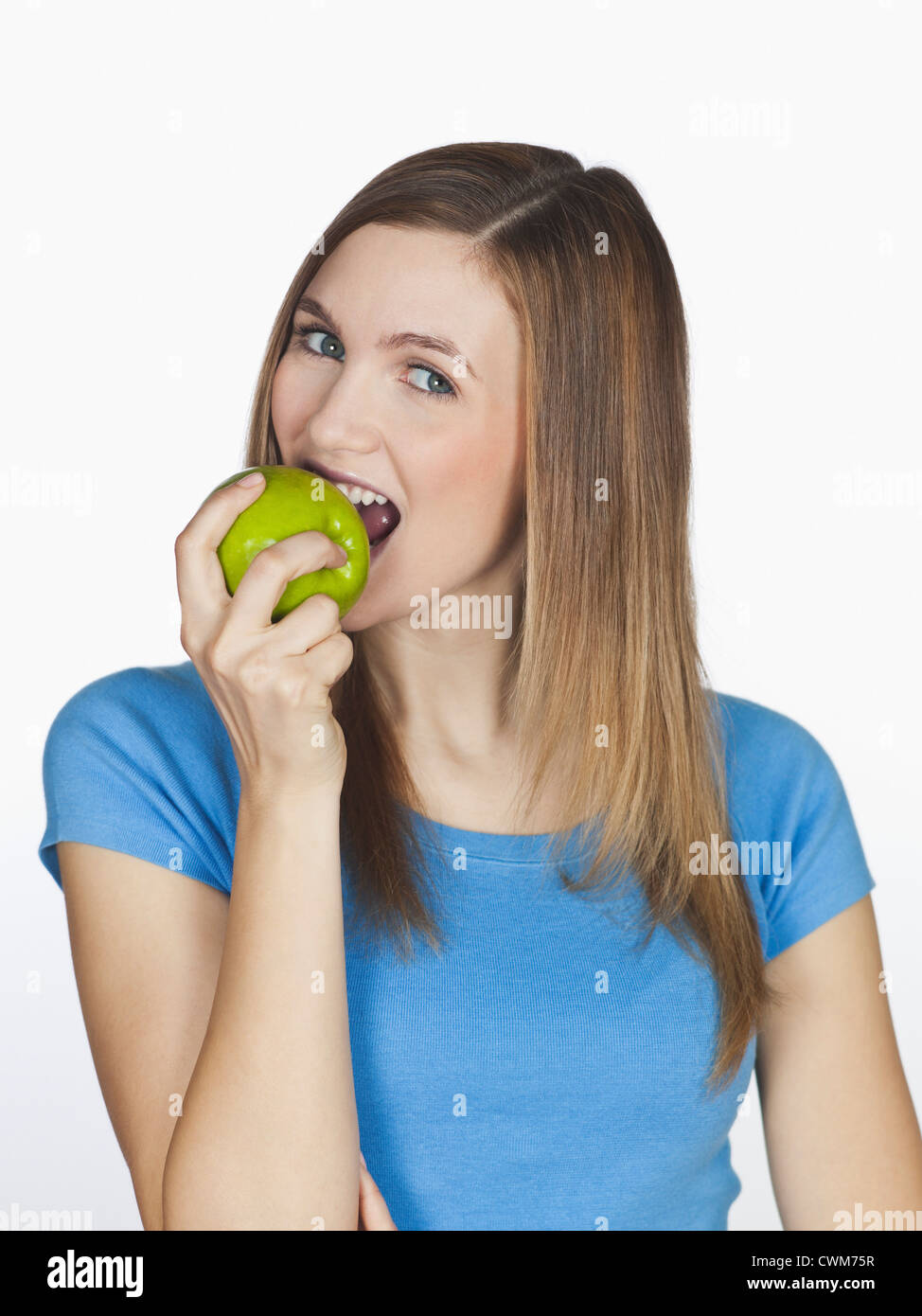 Young woman eating apple, portrait Stock Photo - Alamy
