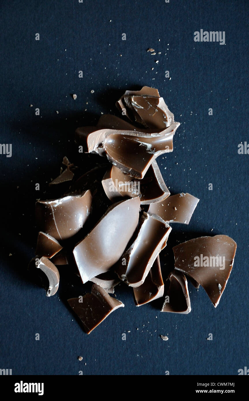 Broken chocolate figurine on coloured background Stock Photo - Alamy