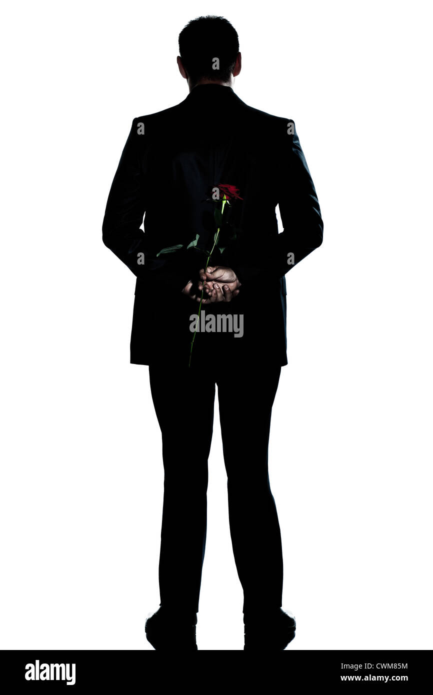 one caucasian backside man holding a rose flower full length silhouette ...