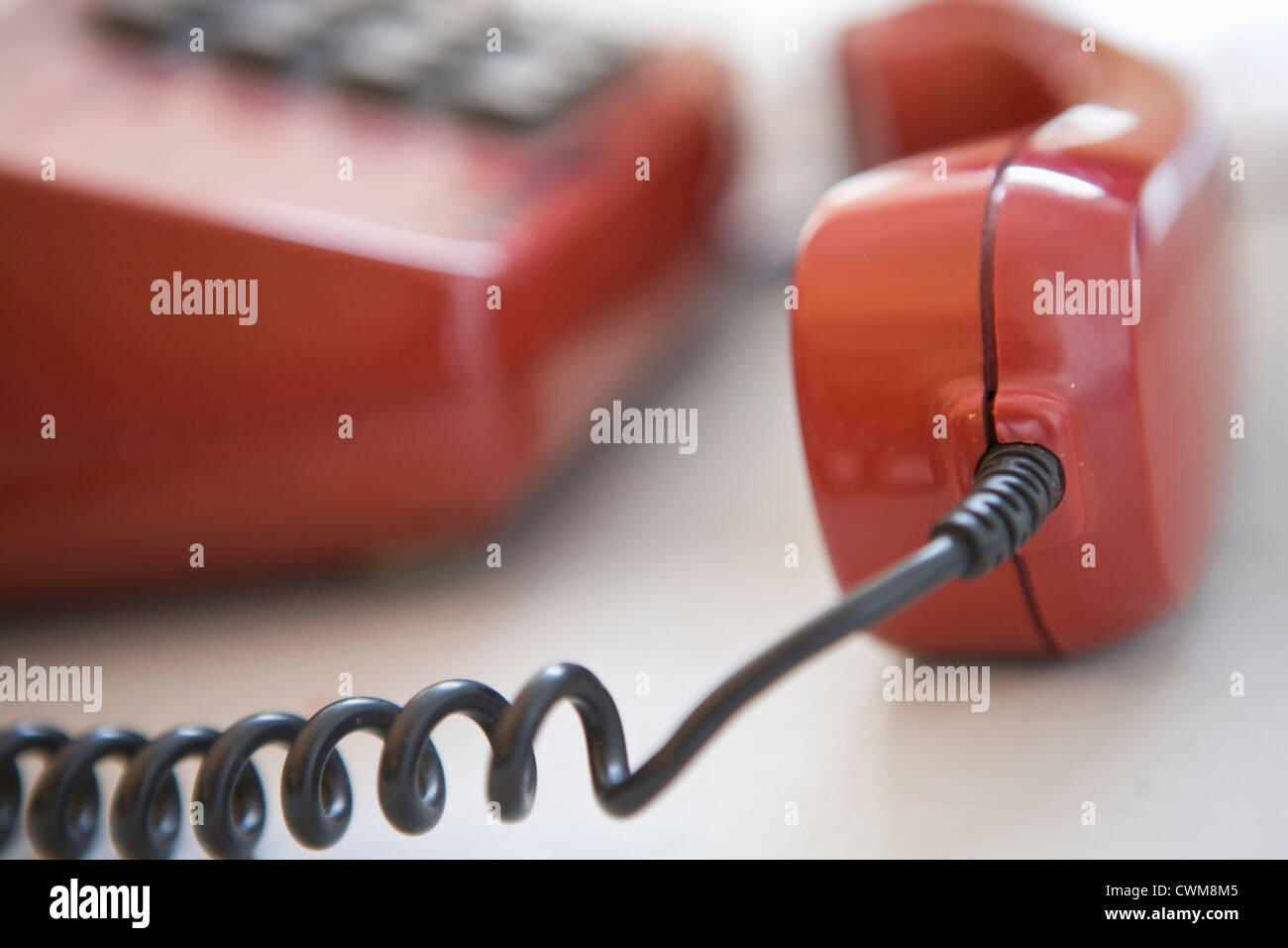 Red telephone on white background Stock Photo - Alamy