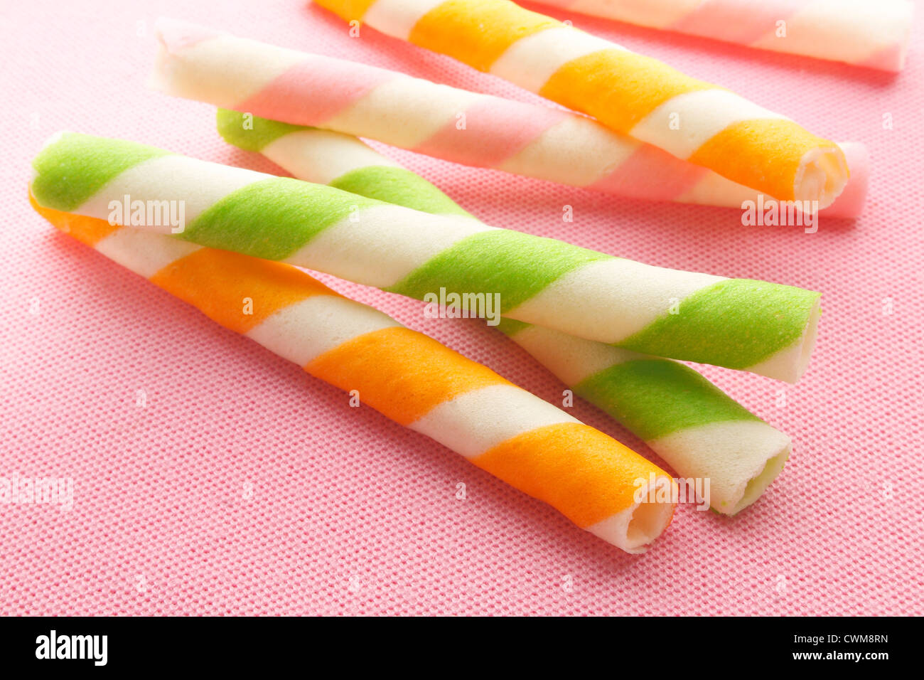strips wafer roll fill with cream on pink background Stock Photo - Alamy
