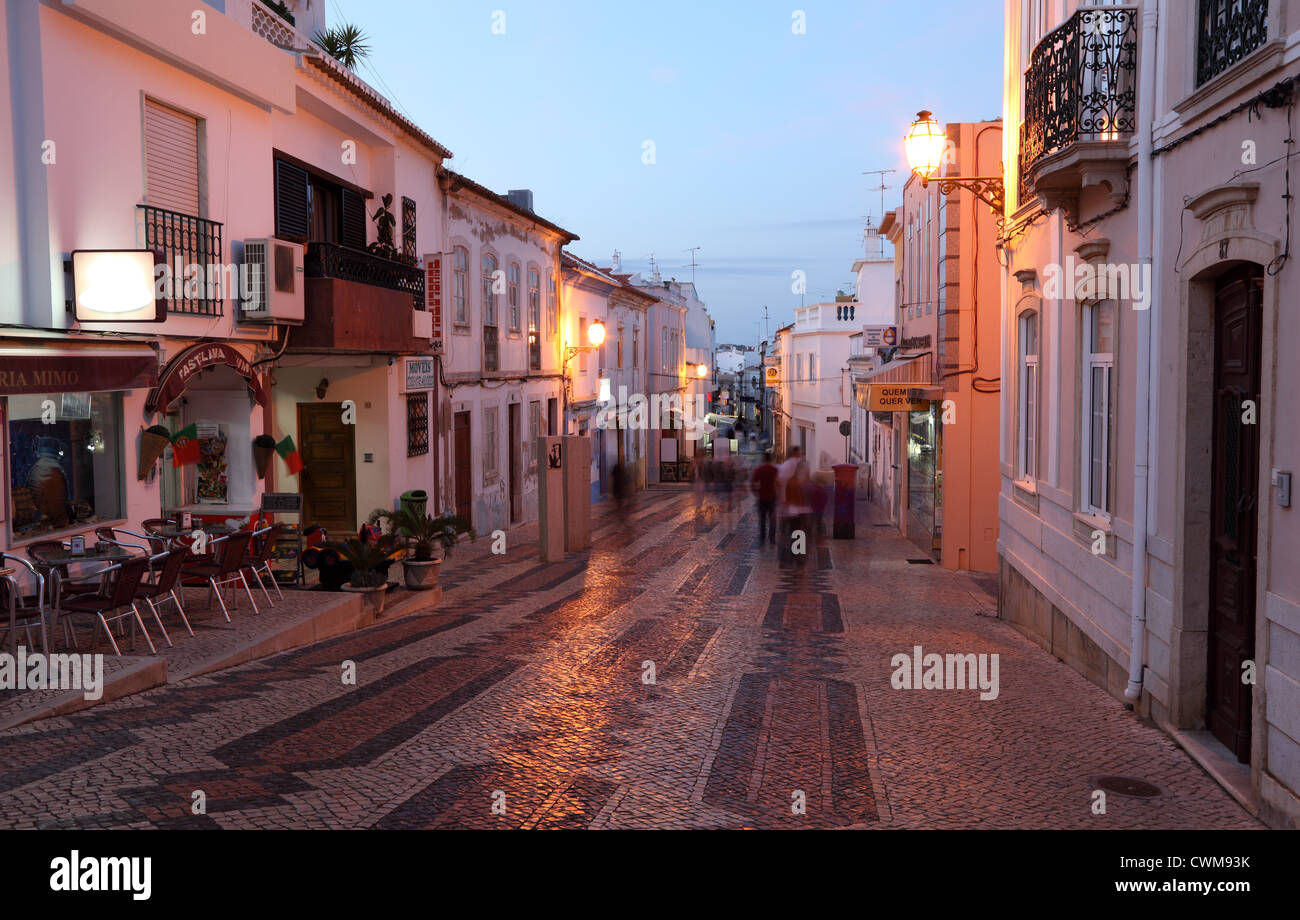 Narrow street in Lagos at dusk, Algarve, Portugal Stock Photo - Alamy