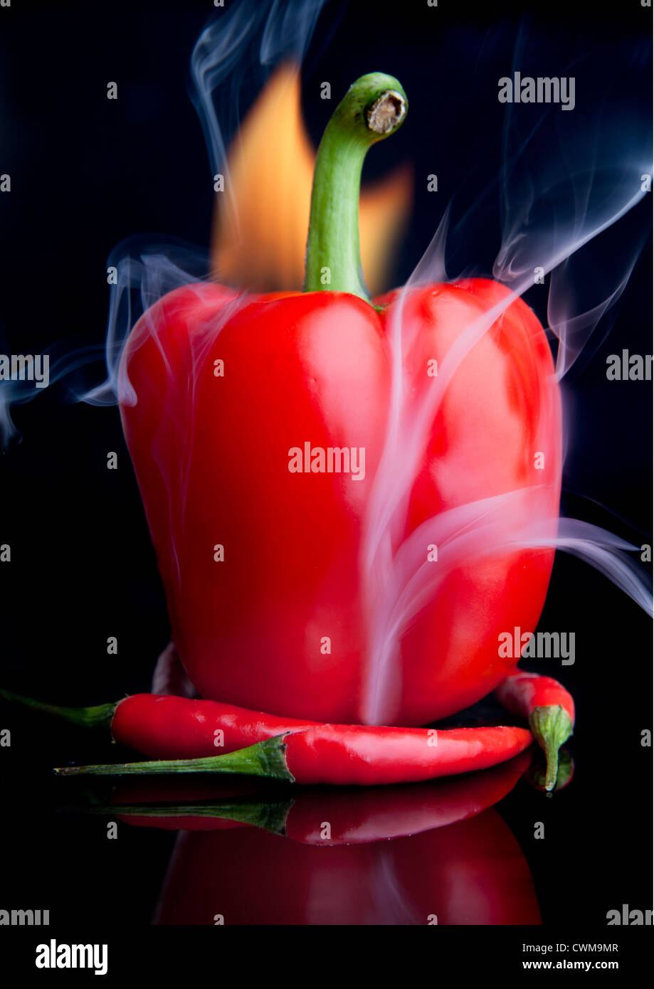 smoking red pepper on fire Stock Photo - Alamy