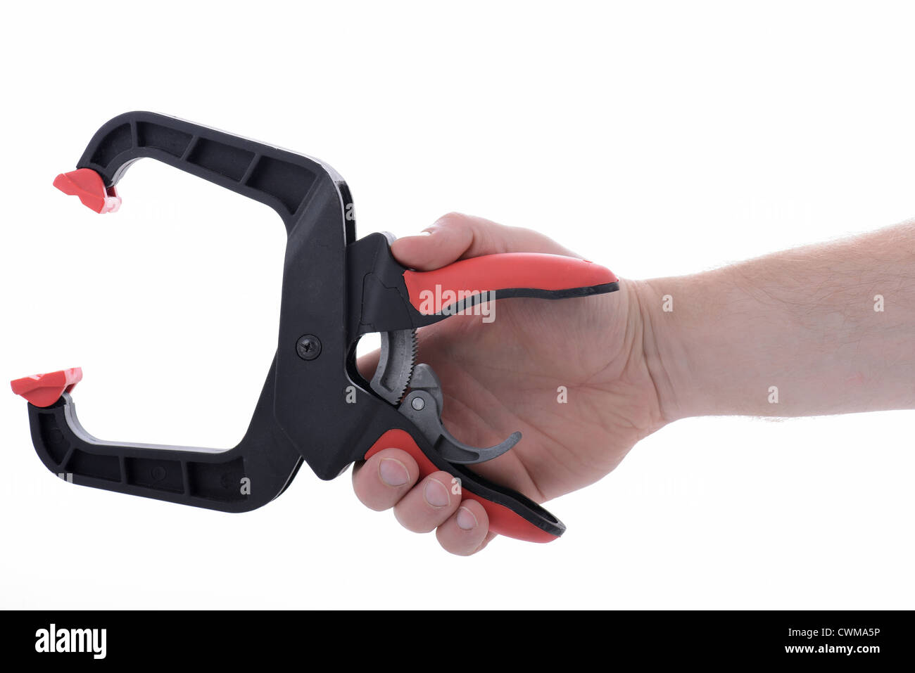 hand holding a clamp isolated on white background Stock Photo - Alamy