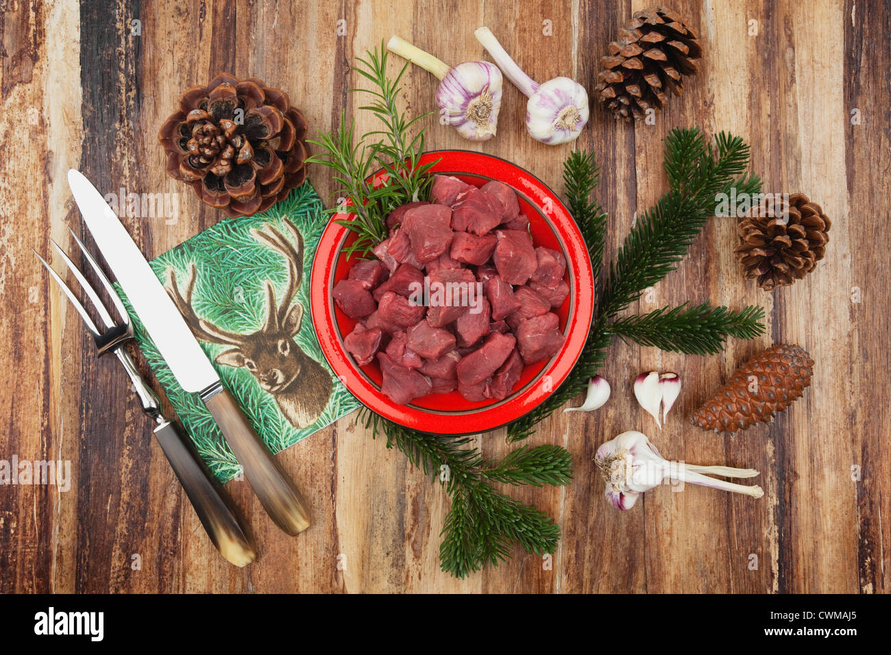 Raw cubed venison meet on ceramic plate with ingredient and Christmas ...