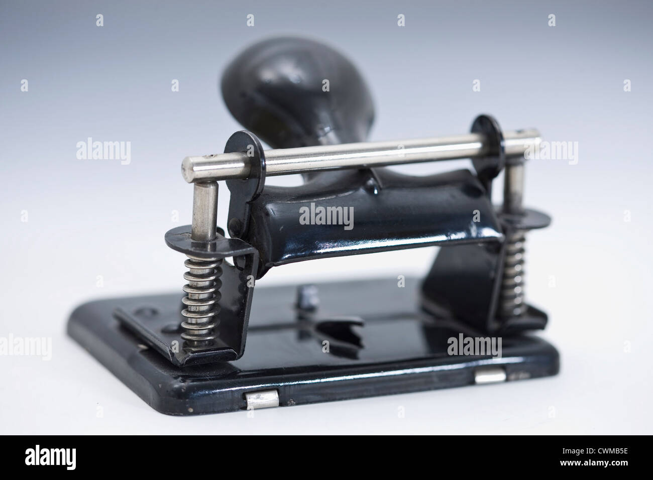 Old hole puncher on white background Stock Photo - Alamy