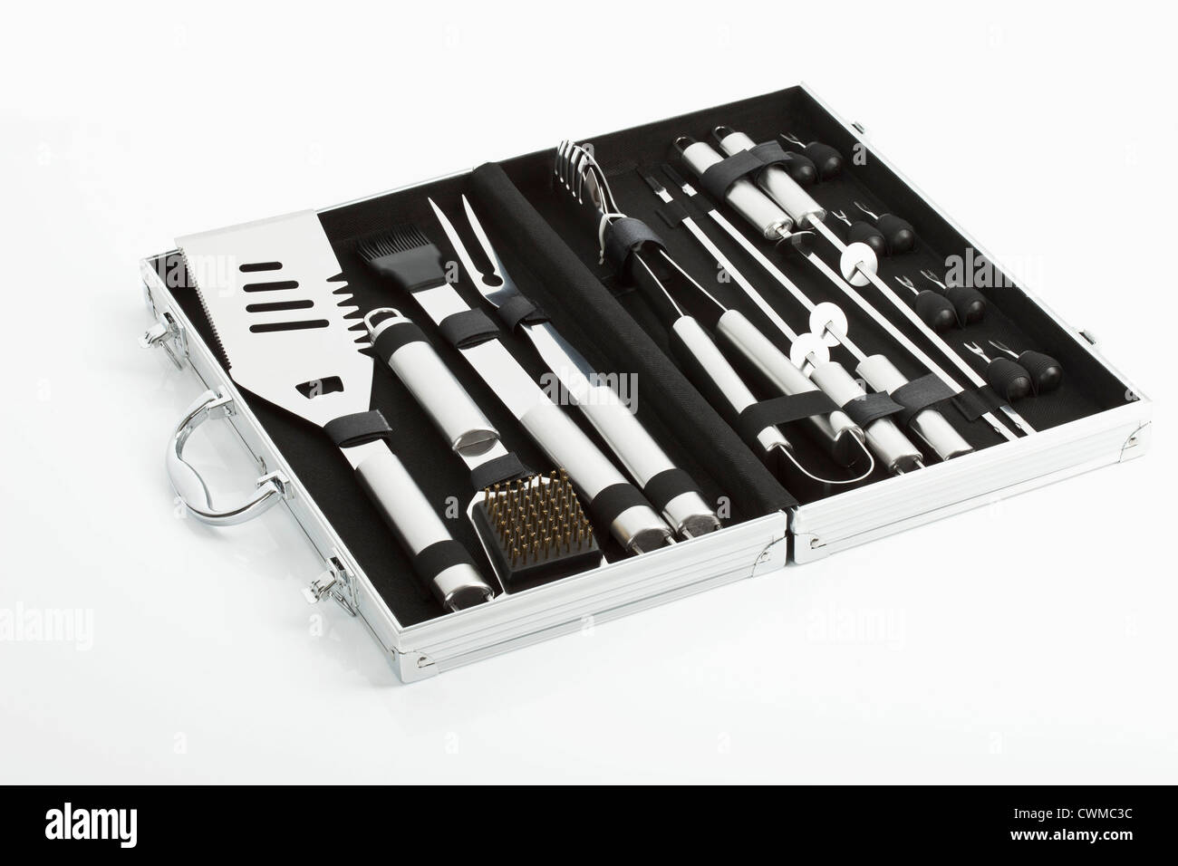 Silver case with barbecue cultery on white background Stock Photo - Alamy