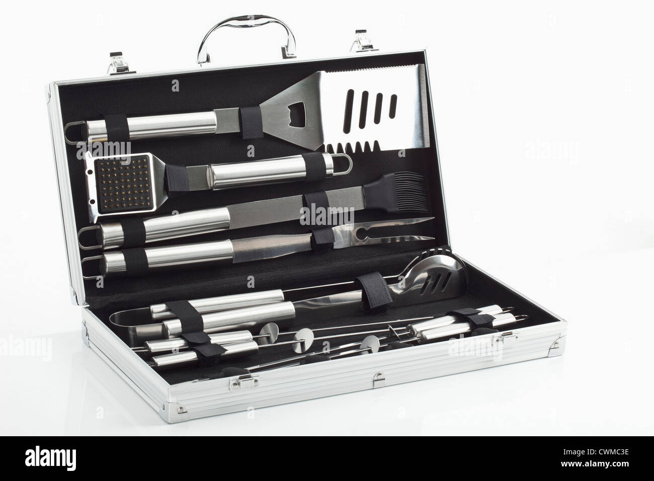 Silver case with barbecue cultery on white background Stock Photo - Alamy