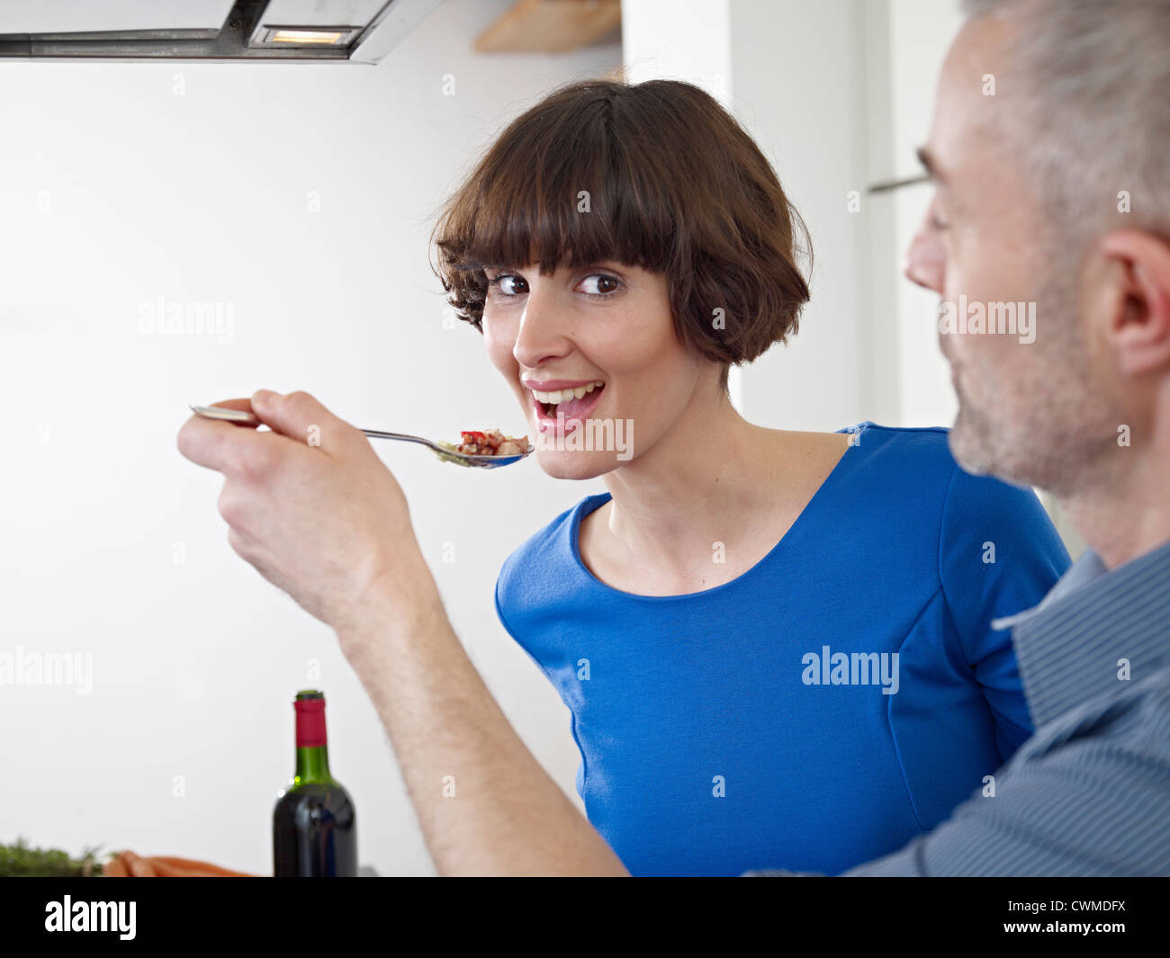 Germany, Cologne, Man feeding woman with spoon Stock Photo - Alamy