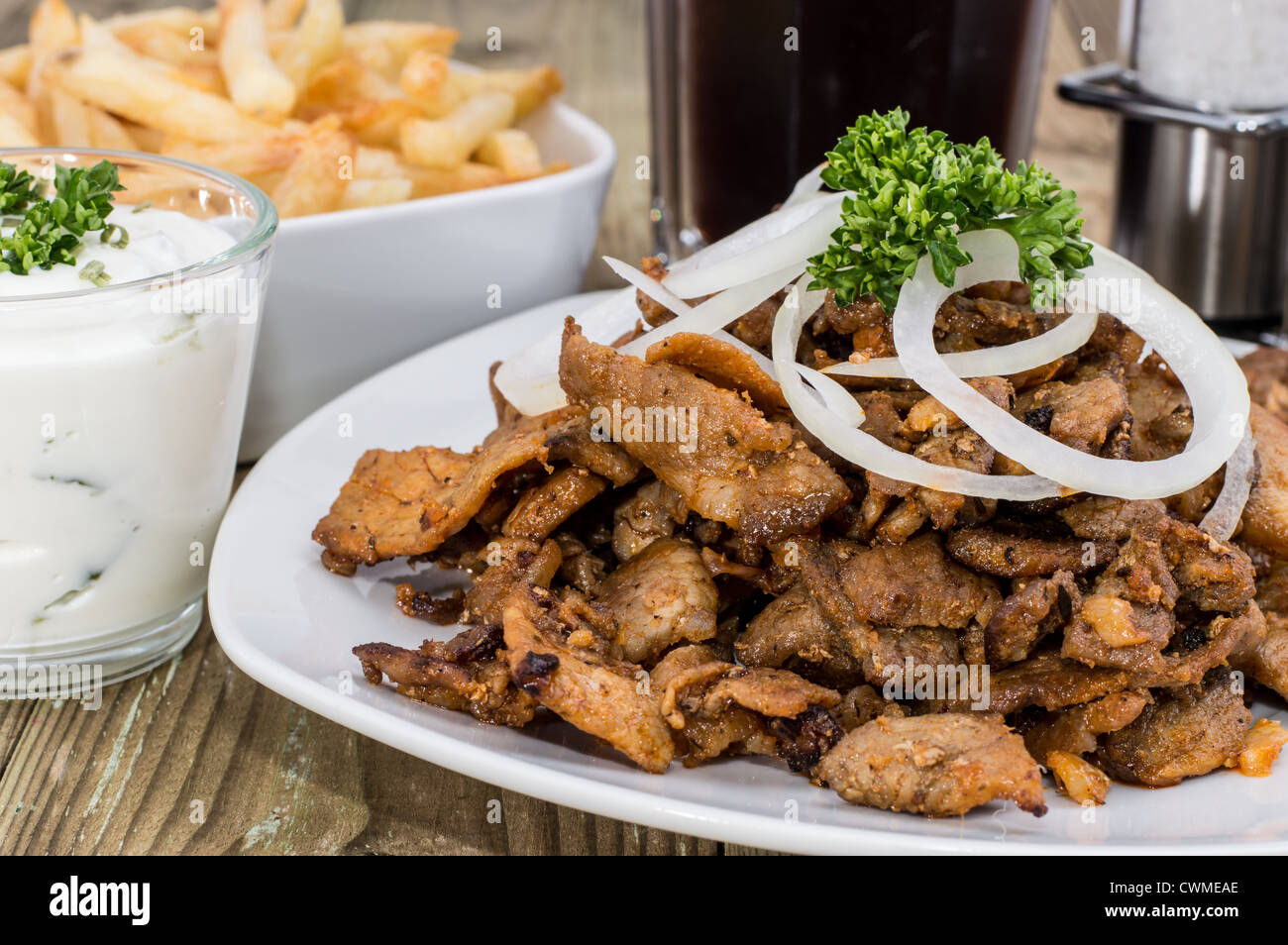 Heap of Kebab meat on a plate on wooden background Stock Photo - Alamy