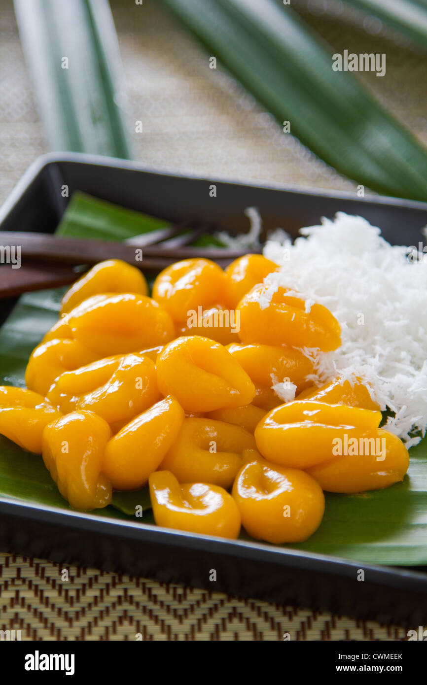 Sweet dumpling made of sticky rice flour with palm with grated coconut ...