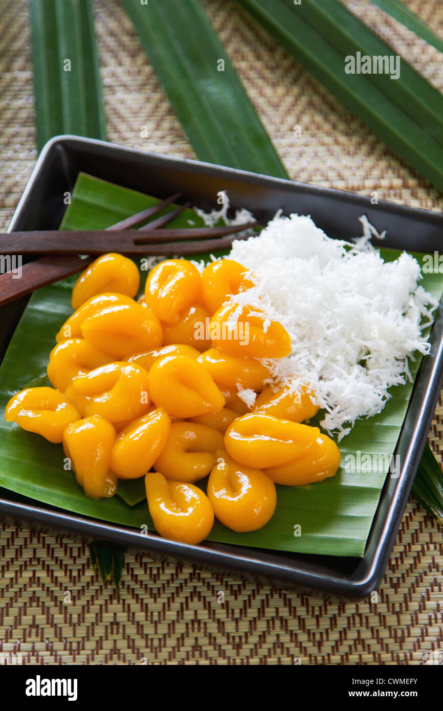 Sweet dumpling made of sticky rice flour with palm with grated coconut ...