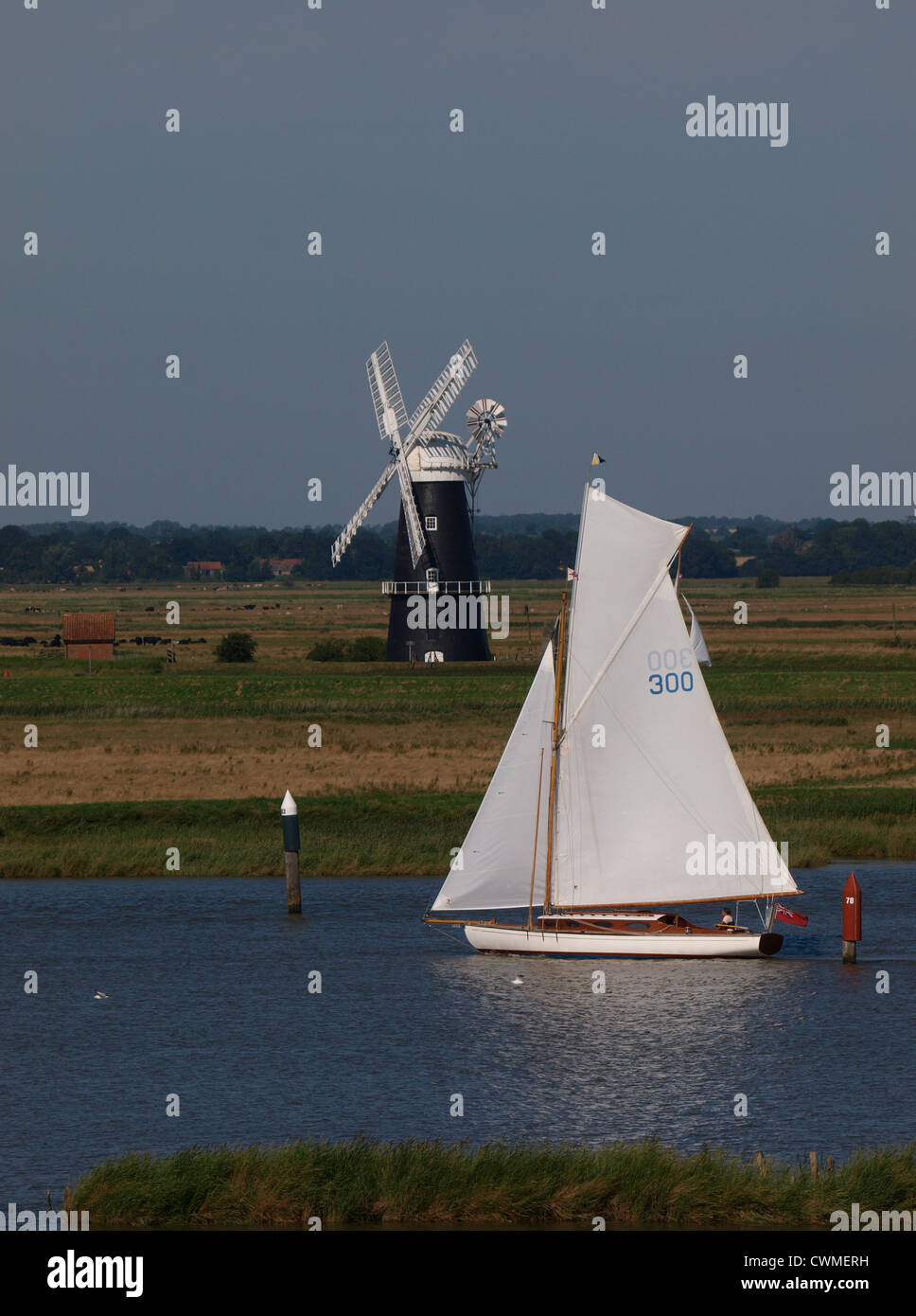 Yacht in front of the Berney Arms Mill, on the bank of the river Yare ...