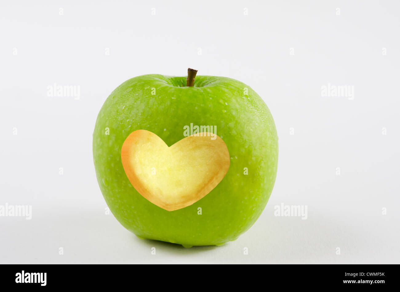 fresh green apple with a heart symbol Stock Photo - Alamy