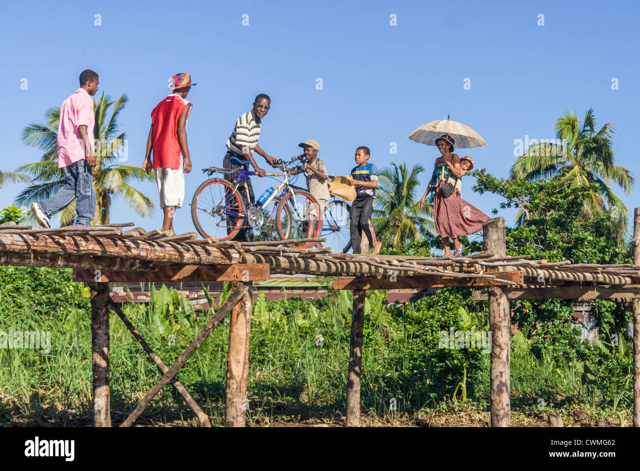 Malagasy people crossing on the wooden bridge Stock Photo - Alamy