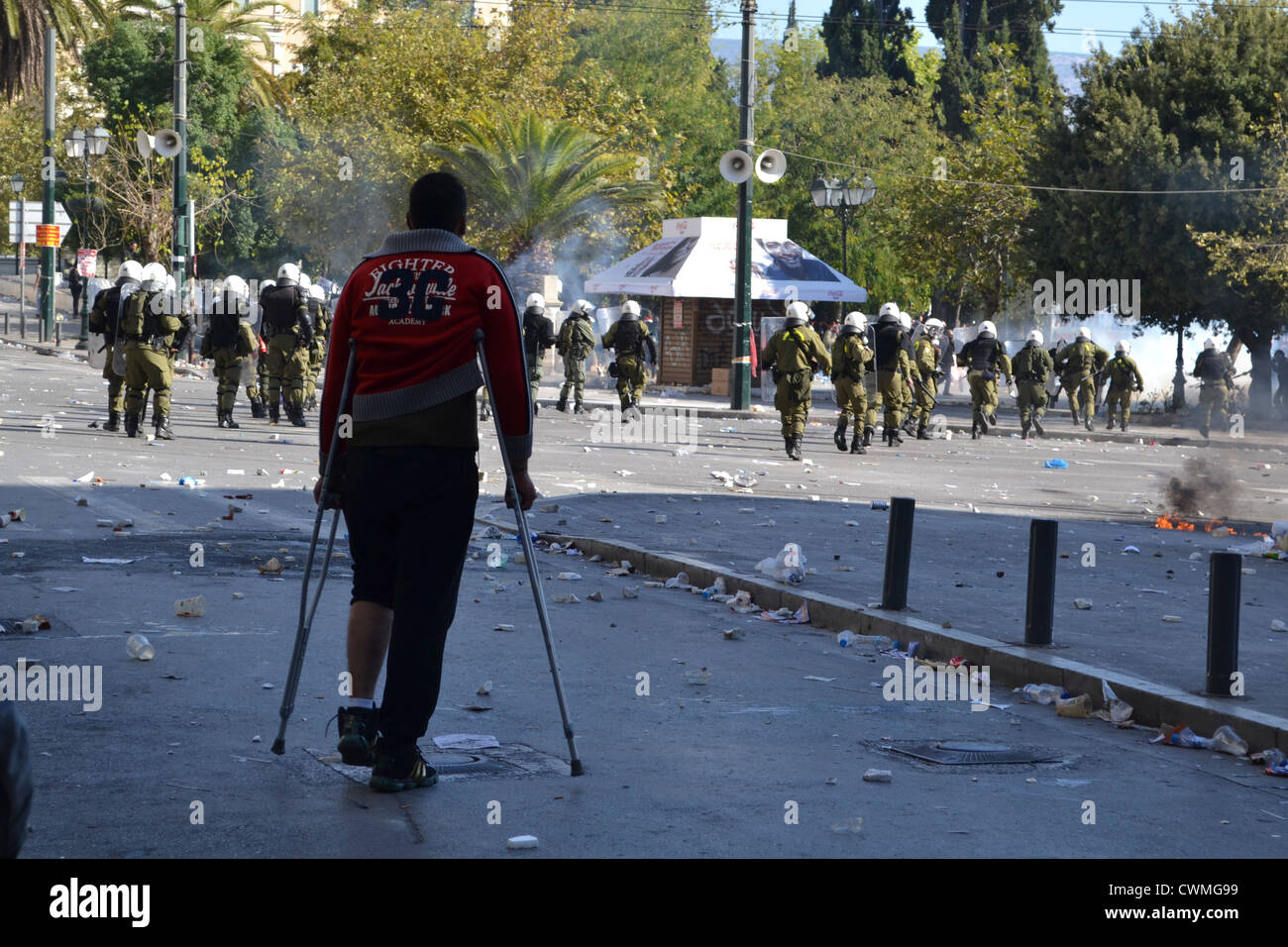 A protester walks on crutches, during riots on a general strike day in ...