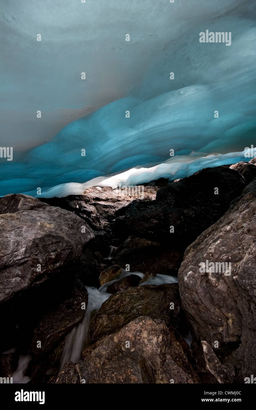 Blue wavy ice shape (glacier) against a valley in Sayan mountains. Wild ...