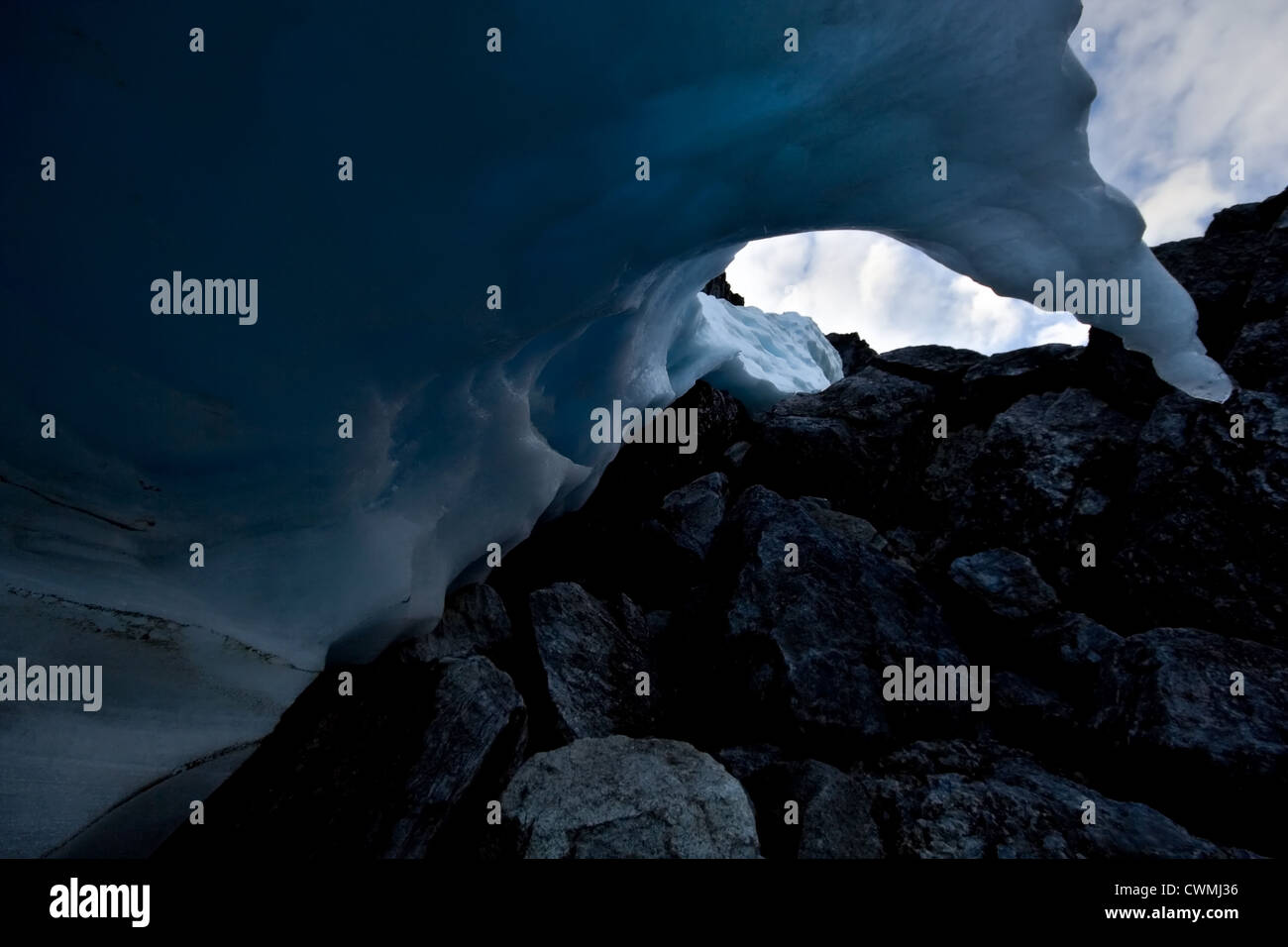 Blue wavy ice shape (glacier) against a valley in Sayan mountains. Wild ...