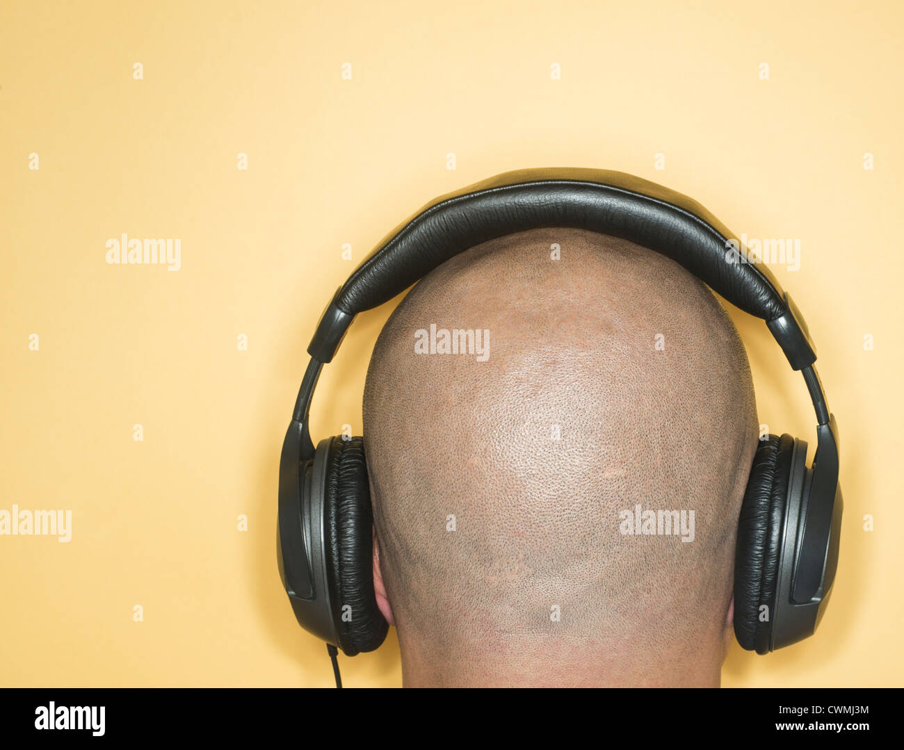 Back view of man with headphones on head Stock Photo - Alamy