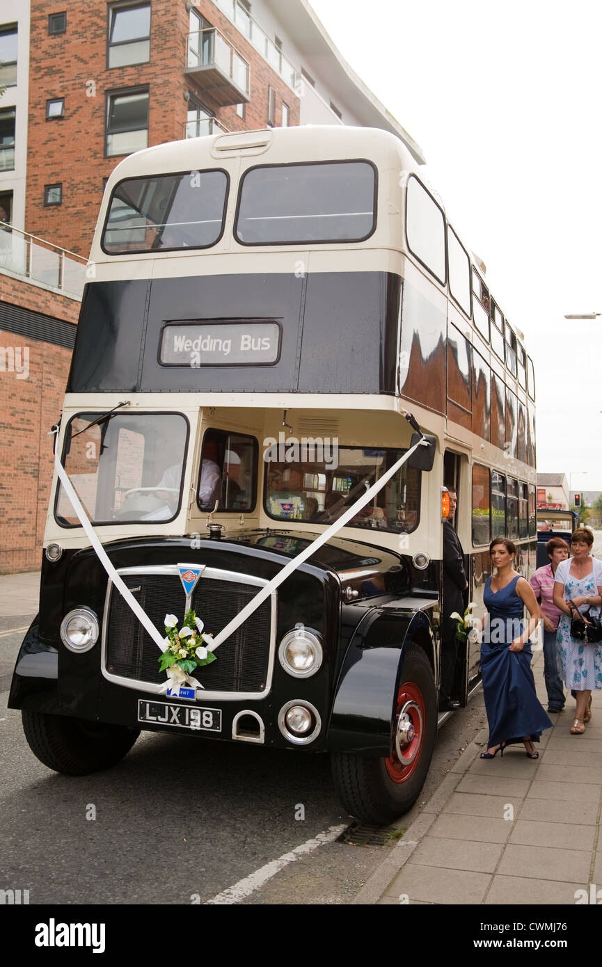 wedding guests boarding a vintage bus Stock Photo - Alamy