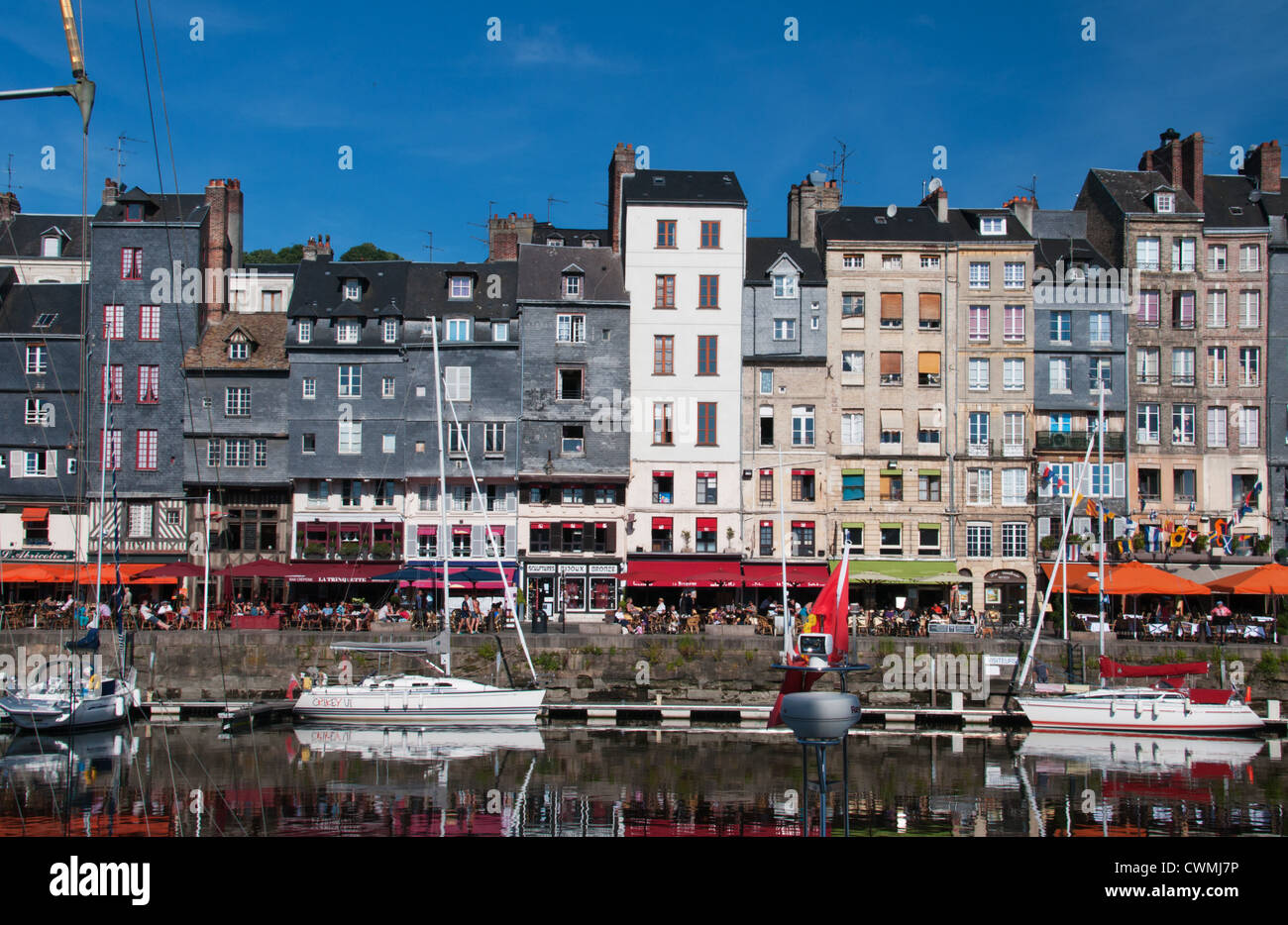 The pretty narrow and irregular houses on Honfleur Old Dock, Basse ...