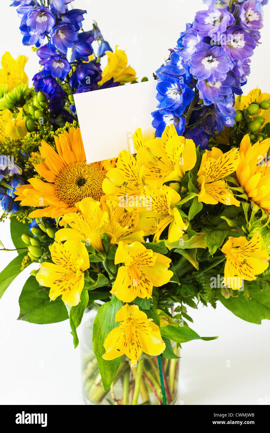 Bunch of colorful flowers in vase with note attached to it Stock Photo ...