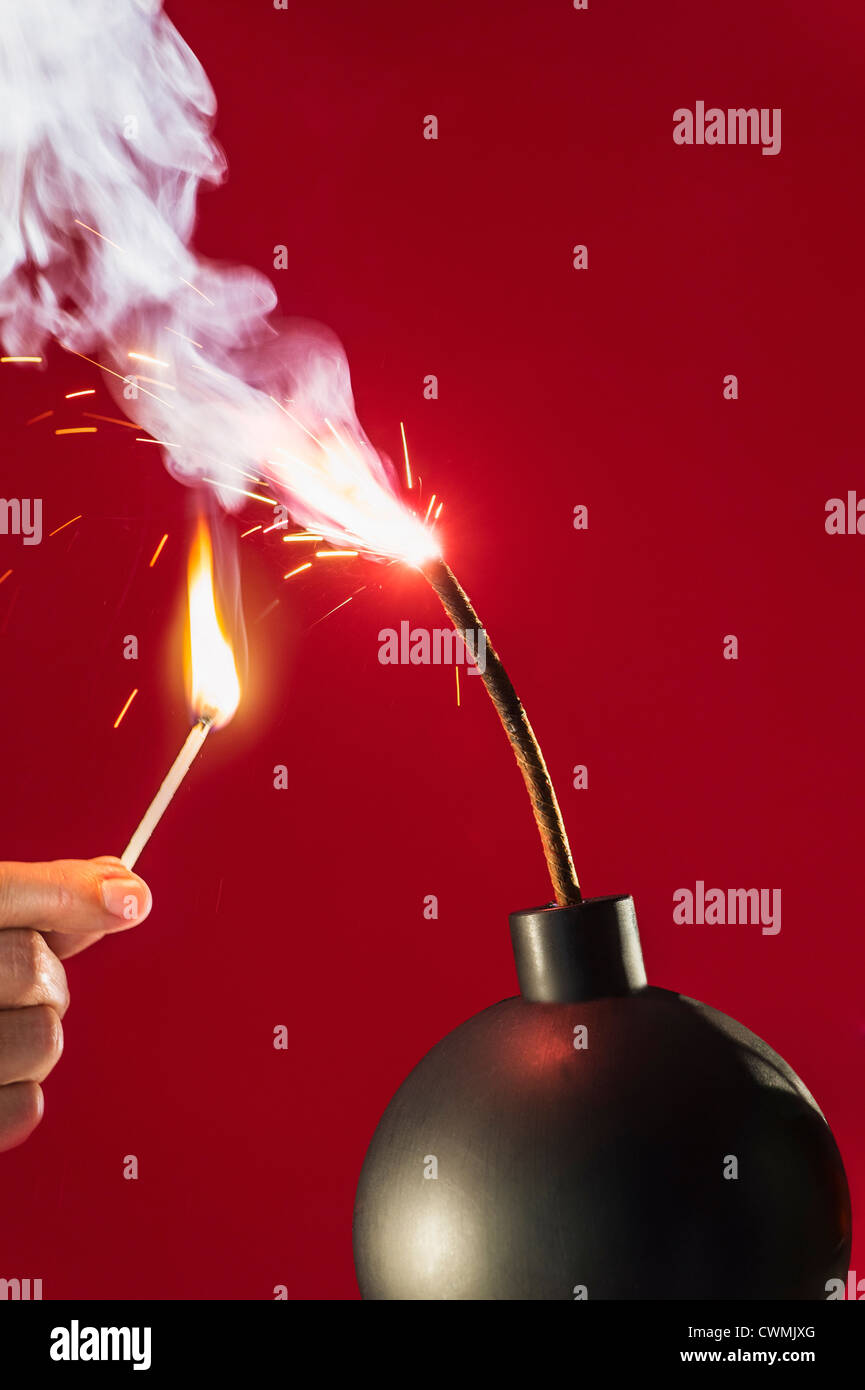 Old-fashioned explosive device ready to go off with hand holding ...