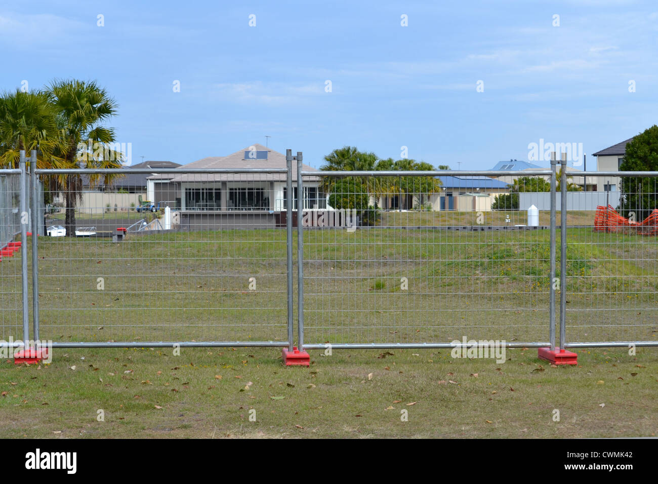 Fenced off canal block of land Stock Photo - Alamy