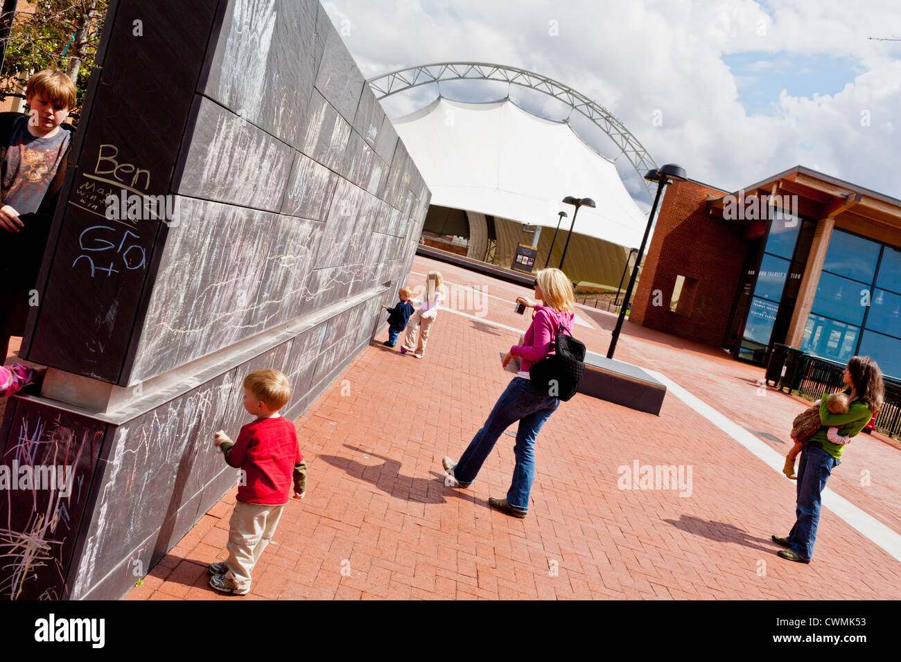 Children draw on Community Chalkboard, mothers watching, Downtown Mall ...