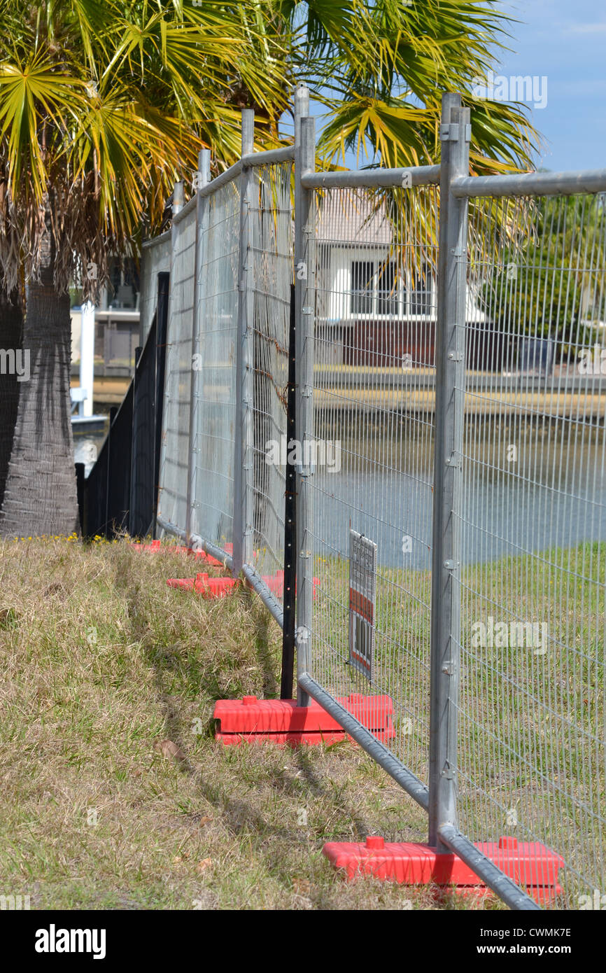 Fenced off canal block of land Stock Photo - Alamy